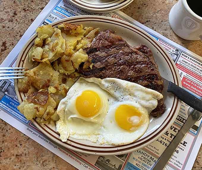 A ribeye steak paired with sunny-side-up eggs proves breakfast doesn't have to whisper when it can confidently shout delicious.