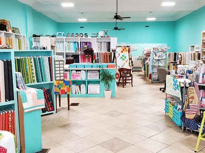 This quilt shop interior bursts with more colors than a box of crayons that got into an argument with a rainbow.
