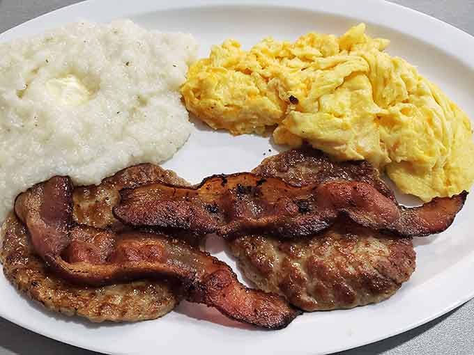 Bacon, sausage, eggs, and grits walk into a diner and create the kind of harmony that makes mornings worth experiencing.