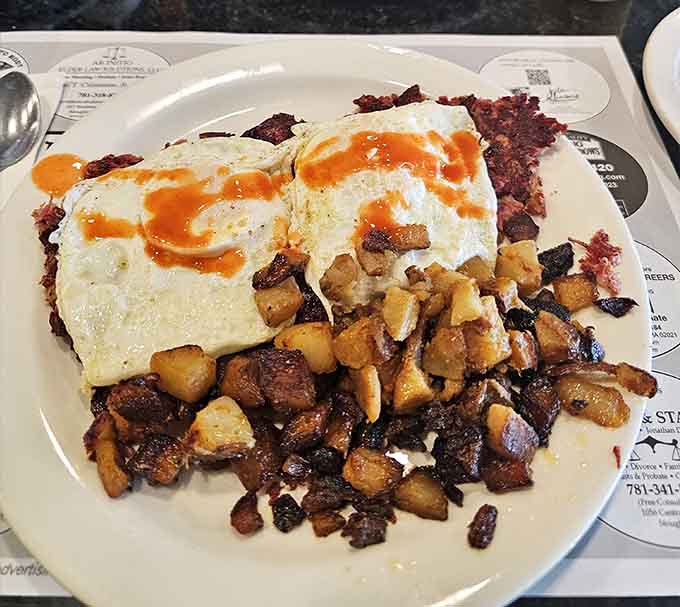 Corned beef hash topped with perfectly cooked eggs, proving breakfast can be both hearty and absolutely magnificent.