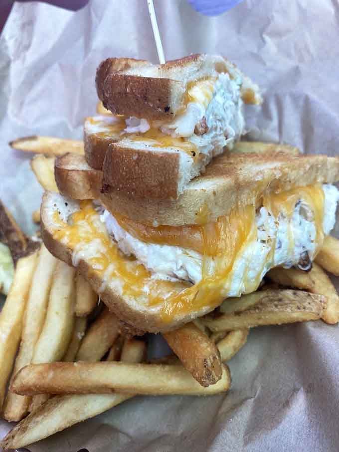 That cheddar melt defies gravity and good judgment. Three stories of melted cheese, crab, and pure coastal indulgence stacked impossibly high.