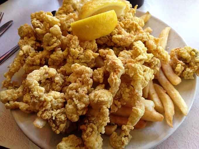 Fried clams piled high enough to require architectural support, proving that sometimes more really is more, especially with seafood.