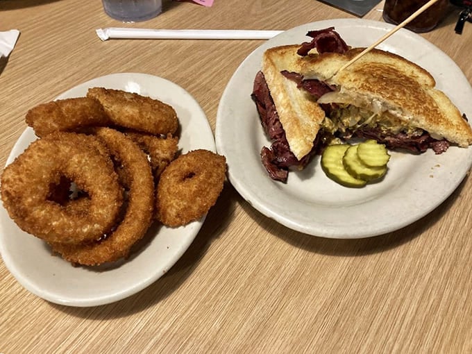 Hot pastrami meets golden onion rings in a combination that'll make your cardiologist schedule an intervention.
