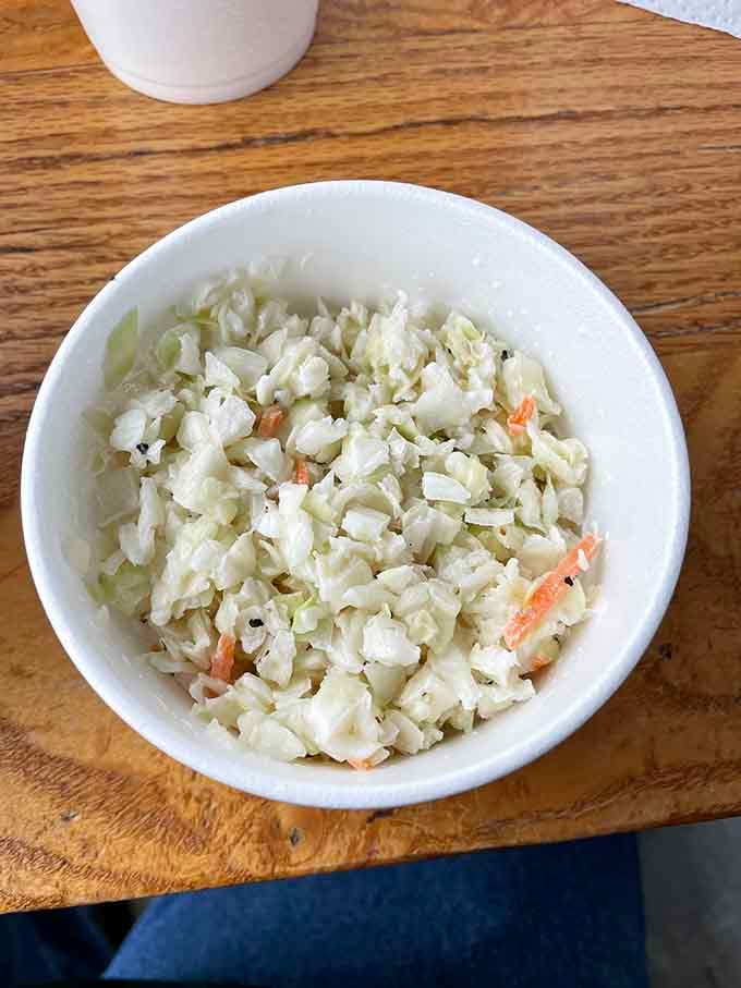 Creamy coleslaw providing that cool crunch your taste buds need between bites of smoky meat heaven.