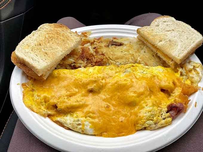Sunshine on a plate: a golden cheese omelet with crispy hash browns and toast. Breakfast doesn't get more comforting than this.