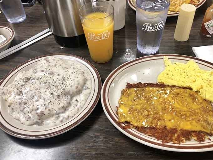 Biscuits and gravy alongside scrambled eggs and hash browns, the kind of plate that makes mornings worth waking up for.