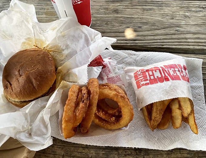 The full spread: burger, fries, onion rings, and a Coke. Lunch doesn't get more American than this.