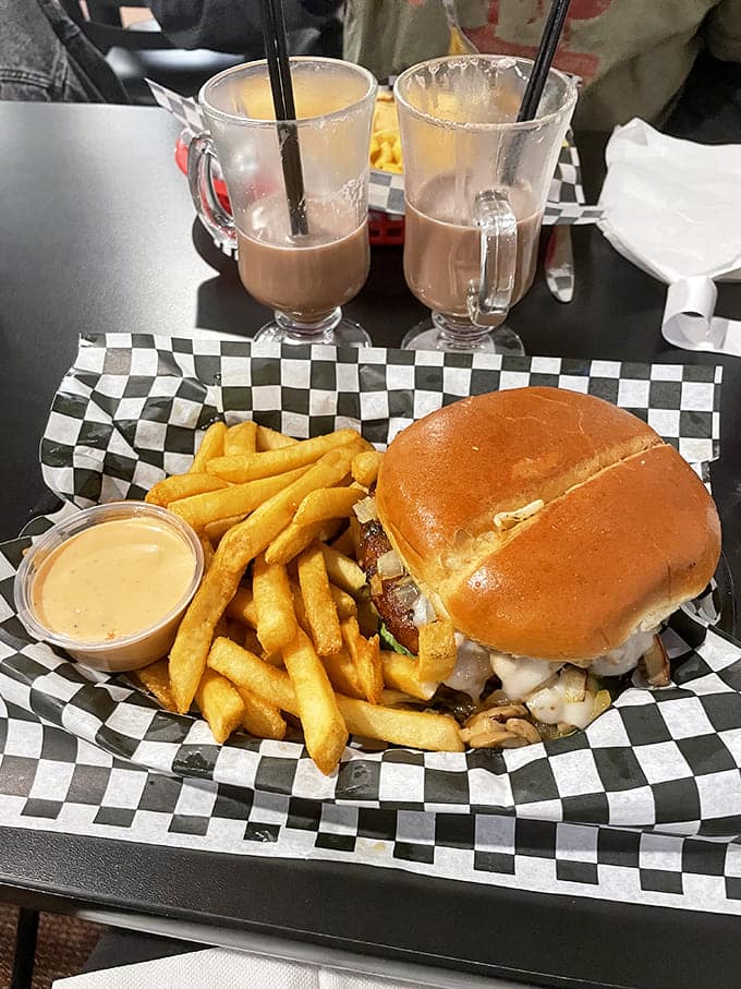 This isn't just a burger and fries&mdash;it's therapy on a checkered paper. Those golden fries look crisp enough to snap like twigs.