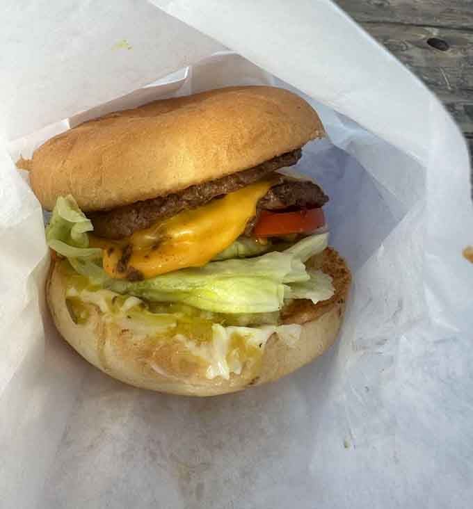 Fresh lettuce, ripe tomatoes, and a juicy patty nestled in a soft bun create burger perfection worth the drive.