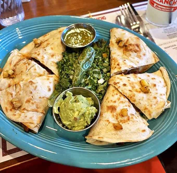 Quesadillas: where tortillas go to fulfill their cheesy destiny. These triangles of joy come with enough guacamole to make an avocado proud.