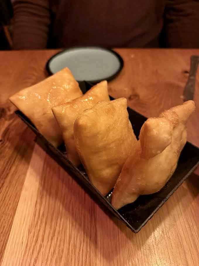 Golden sopapillas drizzled with honey are the sweet finale that makes you forget you just watched someone dive off a cliff.