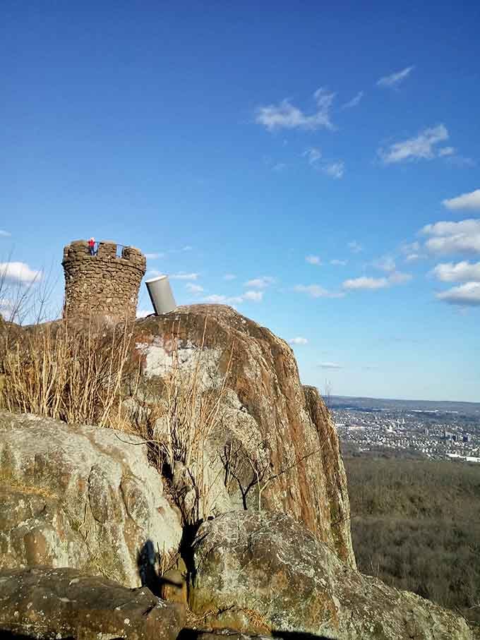 Perched on volcanic trap rock, the tower commands its clifftop position with undeniable medieval authority.