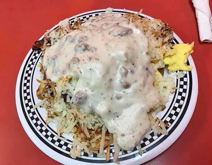 Hash browns smothered in gravy, proving that breakfast doesn't believe in the concept of portion control or moderation.
