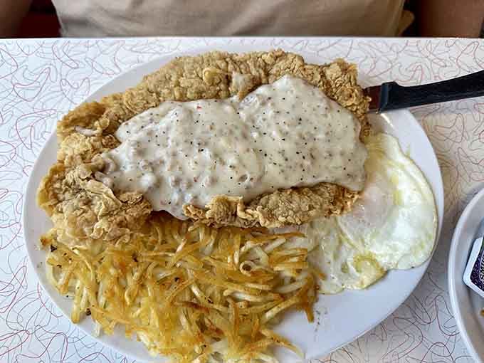 Chicken fried steak blanketed in gravy, because subtlety has no place at the breakfast table on weekends.