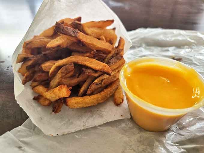 Golden fries with that mysterious orange cheese sauce that somehow tastes like childhood memories. Diet plans surrender at the door.
