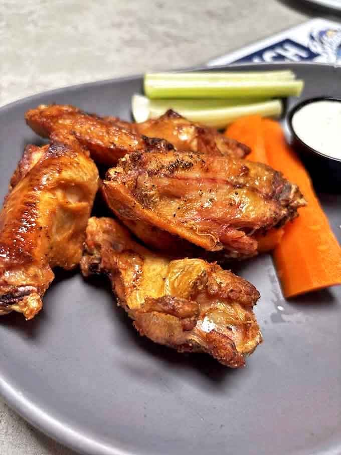 Wings that have clearly been on speaking terms with fire and spice &ndash; crispy on the outside, juicy within, and served with the cooling contrast of fresh veggies.