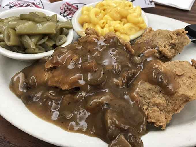 Meatloaf swimming in gravy with sides that remember what vegetables are supposed to taste like.