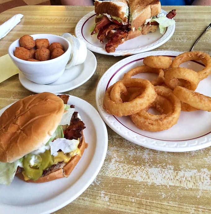 This spread of burgers, onion rings, and breaded mushrooms could feed a small army or one very happy person.