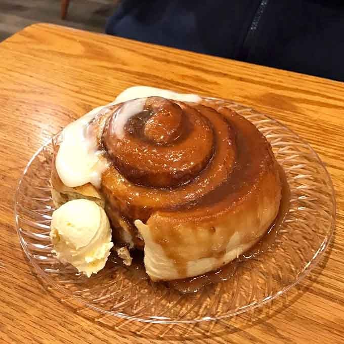 This cinnamon roll isn't just dessert; it's therapy on a plate. The ice cream isn't melting&mdash;it's swooning in the presence of greatness.