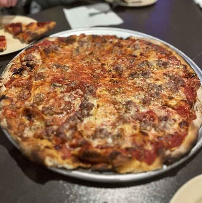 Italian sausage scattered across a perfectly charred crust proves that sometimes tradition beats innovation every single time.