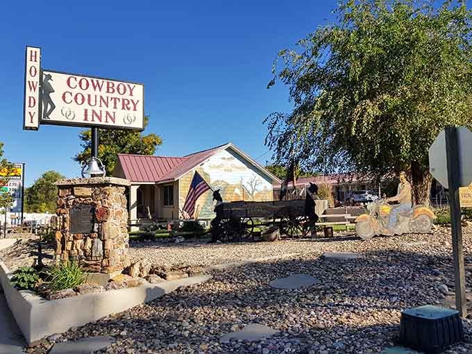 The Cowboy Country Inn embraces its Western heritage without a hint of irony—that wagon isn't decorative, it's autobiographical.