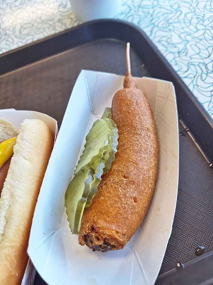 Those pickles aren't just garnish; they're the tangy counterpoint to your crispy, golden corn dog symphony.