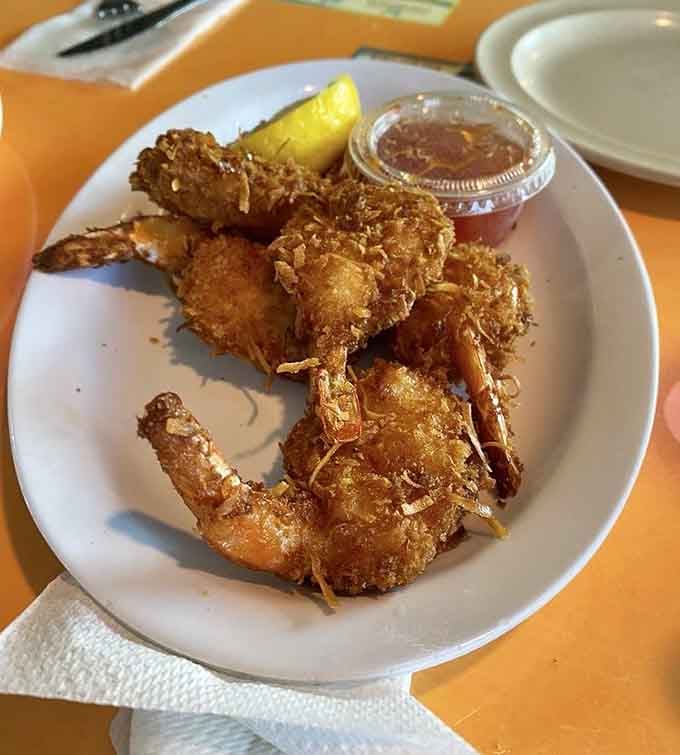 Coconut shrimp wearing their crispy jackets like they're headed to a tropical party you want attending.
