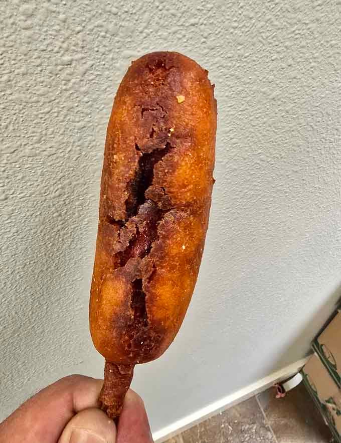 Corn batter hugging a hot dog on a stick, childhood fair memories served fresh from the fryer.