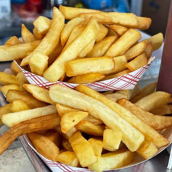 These aren't just fries, they're golden batons of crispy perfection that deserve their own standing ovation.