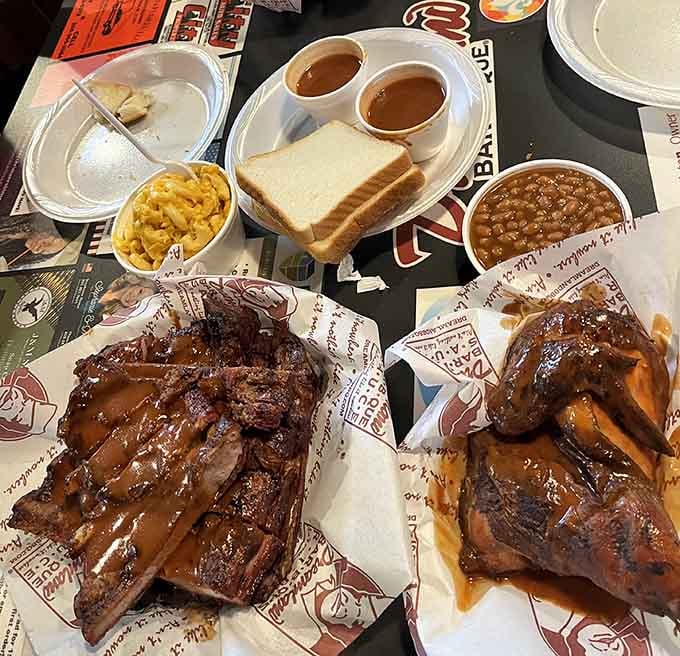 White bread, sauce cups, and ribs: the holy trinity of Alabama barbecue served on paper that can't contain the glory.