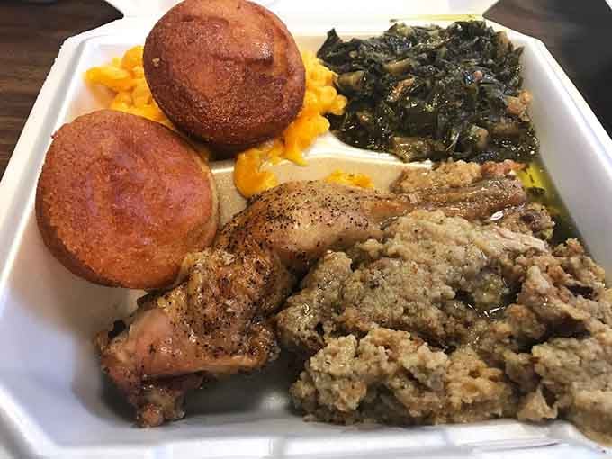 Fried chicken, cornbread, collards, and mac and cheese, basically the Mount Rushmore of Southern comfort on one plate.