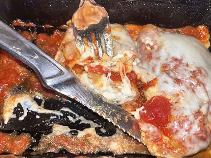 Hidden beneath that blanket of melted cheese and marinara lies the perfect marriage of crispy exterior and creamy eggplant&mdash;a textural symphony on a plate.