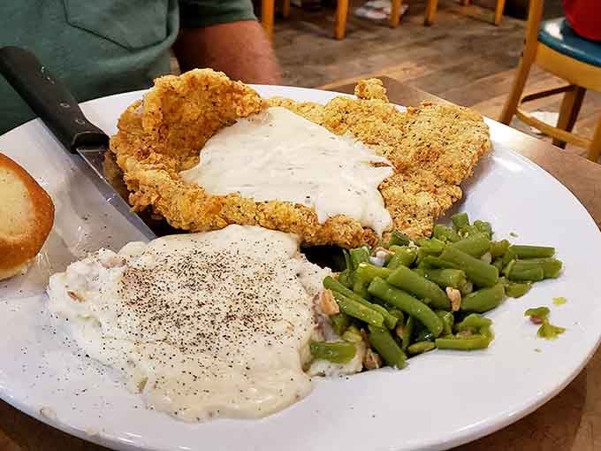 Country fried steak smothered in white gravy, the kind of plate that makes your cardiologist nervous and you happy.