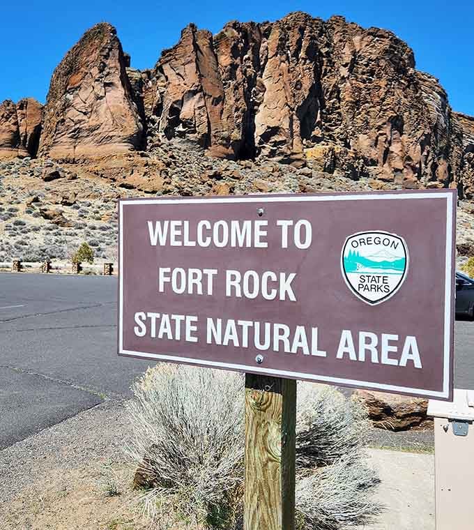 Welcome signs never looked so good when there's a geological wonder looming dramatically in the background.
