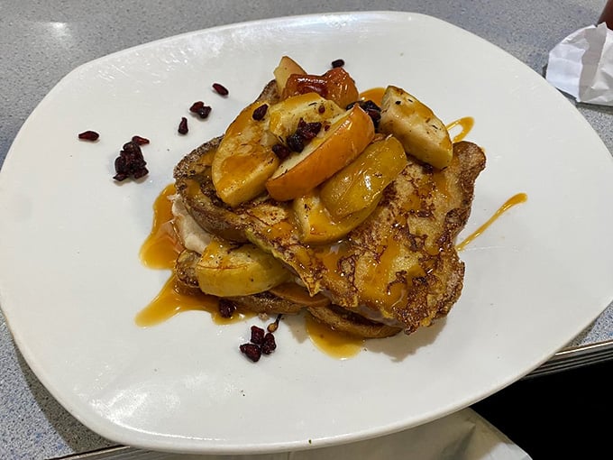 French toast topped with caramelized fruit that looks almost too pretty to eat, but you absolutely will anyway.