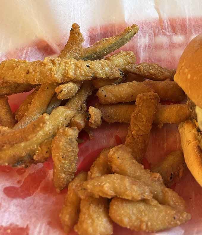 Fried pickle spears – the unexpected sidekick that steals the show with their tangy crunch and golden armor of seasoned batter.