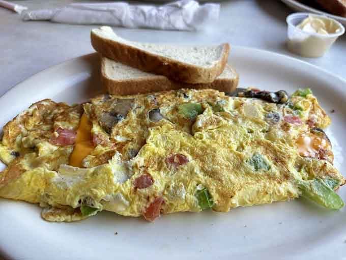 An omelet so loaded with goodness, it practically needs architectural support to stay standing on the plate.