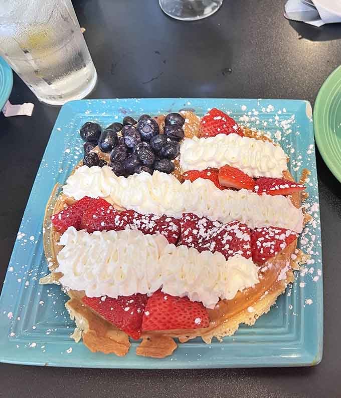 A patriotic waffle topped with berries and cream, proving breakfast can be both delicious and Instagram-worthy.