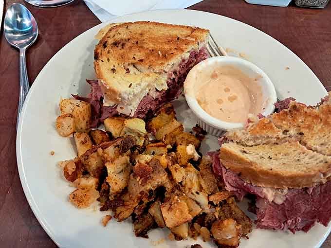 That reuben sandwich is stacked so high, it makes skyscrapers jealous of its architectural ambition and flavor.