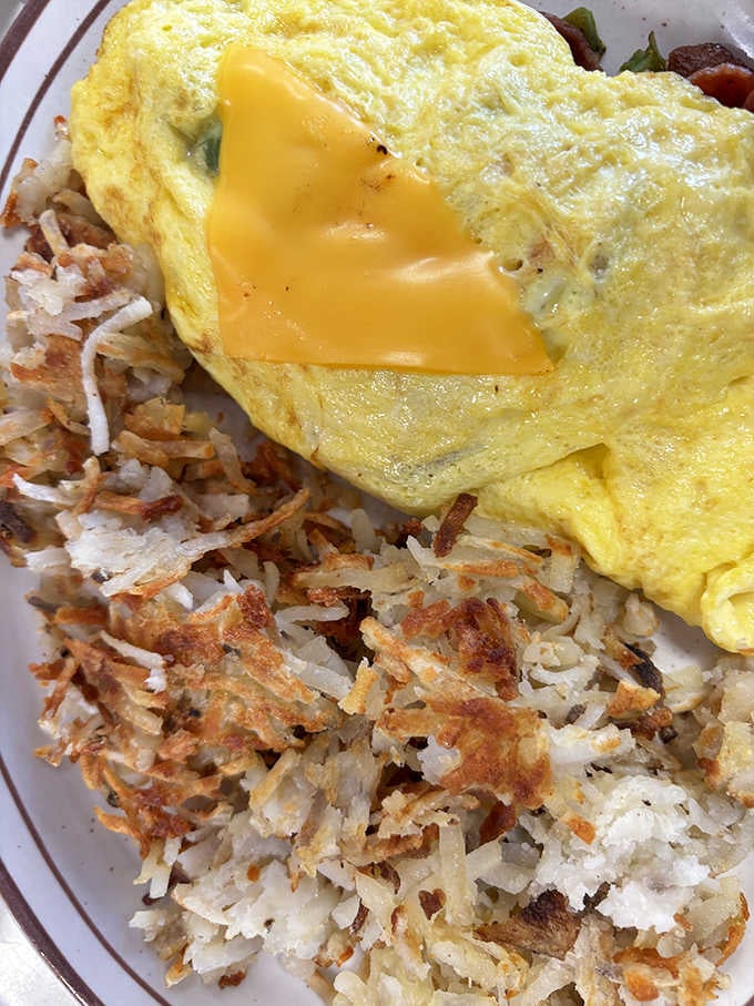 This cheese-topped omelet with perfectly crisped hash browns is what breakfast dreams are made of. Diet starts tomorrow, obviously.