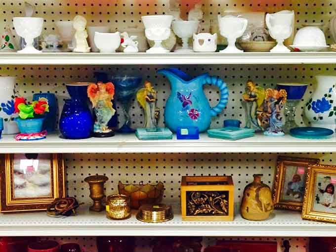 The home decor aisle—where blue glass pitchers and milk-white collectibles create a museum of American domestic life, priced for everyday collectors.