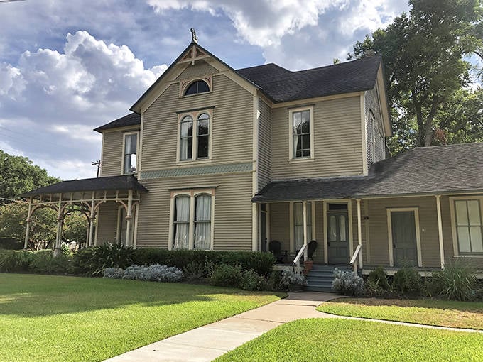 The Horlock House wears its Victorian charm like a well-tailored suit, its wraparound porch practically begging you to sit a spell with a glass of sweet tea.