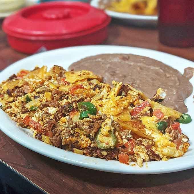 Huevos Mexicana con Chorizo: Where breakfast meets art, creating a colorful canvas of flavors that puts your sad bowl of cereal to shame.