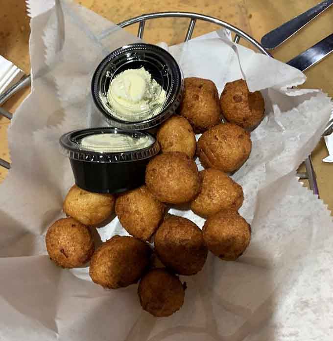 Hush puppies so perfectly golden they deserve their own trophy, served with butter cups that whisper, "Go ahead, indulge a little more."