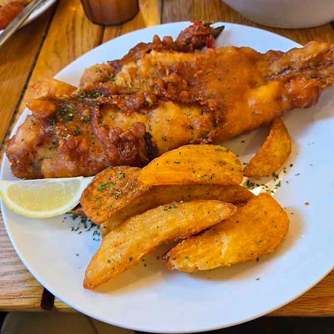 Fried fish and seasoned wedges proving that simple preparations often yield the most spectacular results every time.