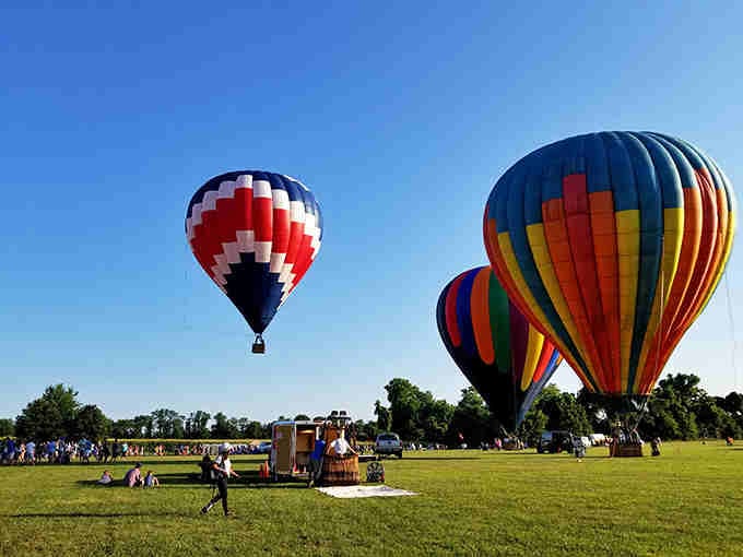 Hot air balloons floating above the fields add a splash of whimsy to this already magical landscape.