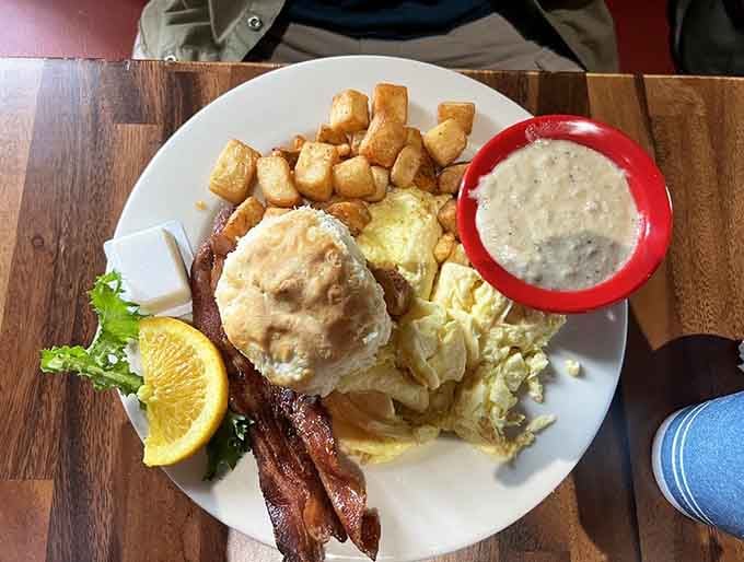 This breakfast plate showcases perfectly cooked eggs, crispy bacon, and those golden potatoes that complete the picture.