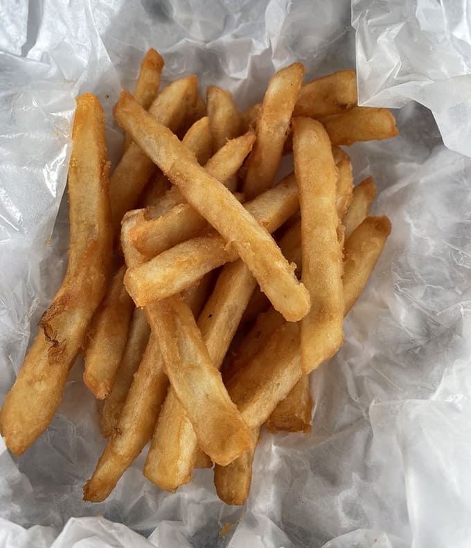 Golden crinkle-cut fries that understand their sacred duty: being the perfect vehicle for ketchup and happiness.