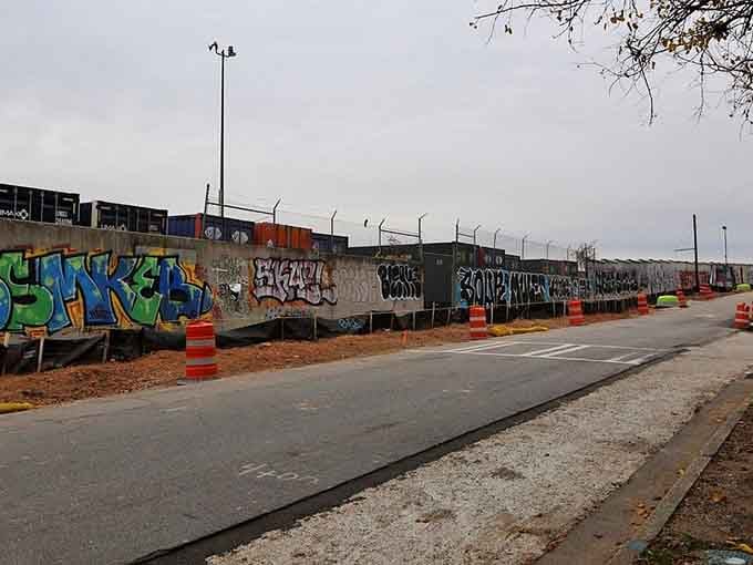 Railroad tracks overhead frame this outdoor gallery, where trains rumble past oblivious to the masterpieces blooming below them.