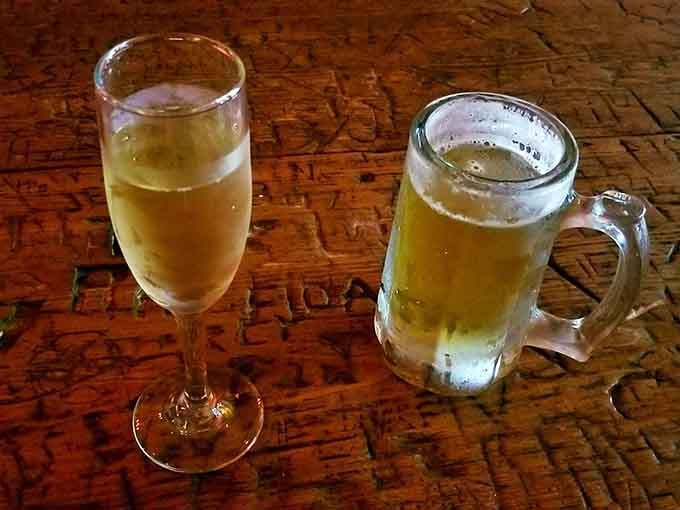 Beer and champagne on a table that's absorbed more conversations than your therapist ever will in life.